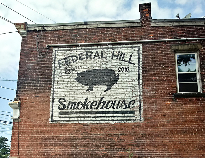 The painted sign serves as Erie's smoke signal: authentic barbecue happens here. No fancy frills, just a pig and a promise.