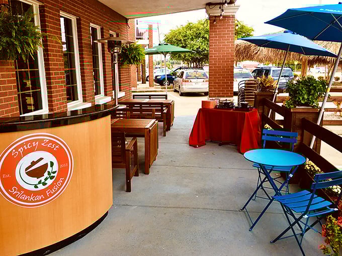 Outdoor seating with pops of blue and red offers Texas sunshine with your Sri Lankan spice&mdash;nature's perfect dining companion.