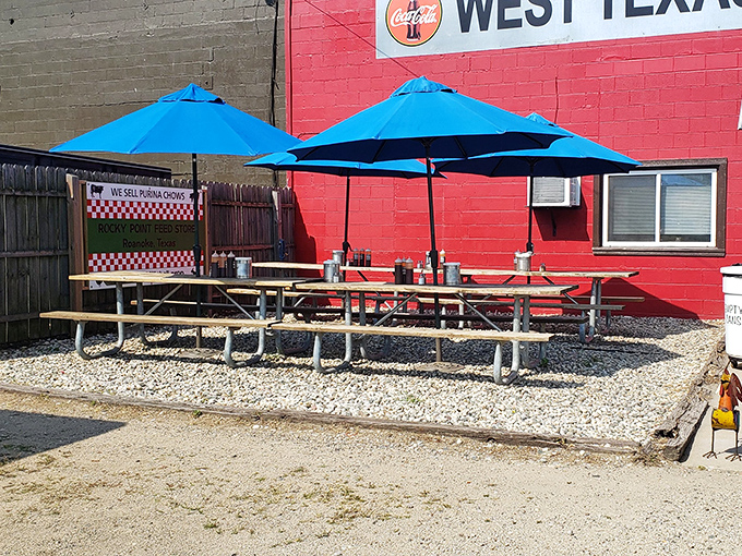 Outdoor seating that says, "Why wait to get home? Dive in now!" Those blue umbrellas provide shade for serious barbecue contemplation.