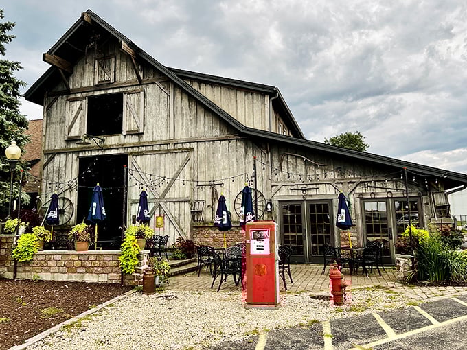 The outdoor seating area offers al fresco dining against the weathered barn backdrop, complete with vintage gas pump for that extra touch of nostalgia.