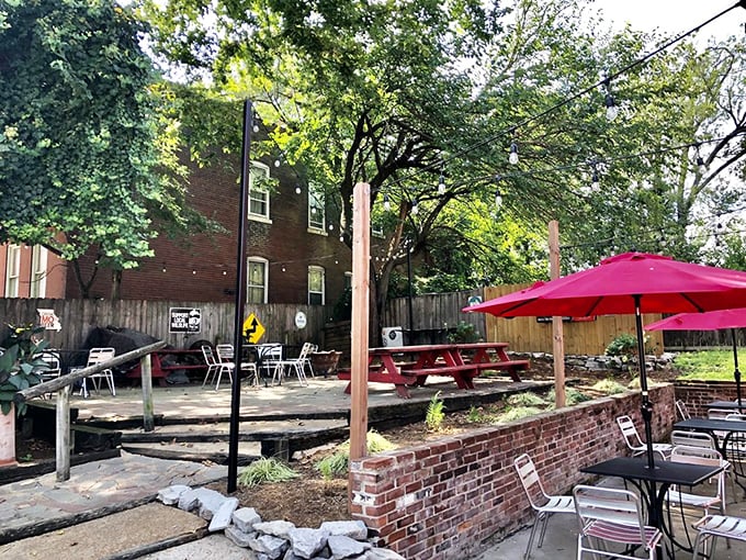 Outdoor seating nestled among trees offers a perfect urban oasis. Picnic tables and umbrellas invite you to linger just a little longer.