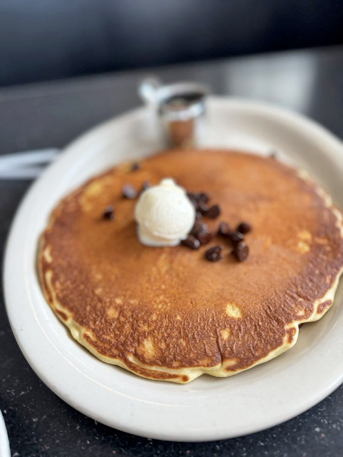 A pancake so perfectly golden it deserves its own sunrise soundtrack&mdash;topped with a melting pat of butter and chocolate chips for good measure.
