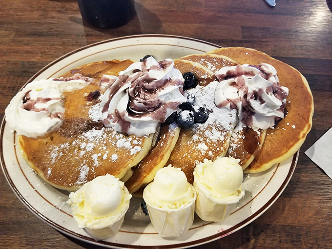 Pancakes that don't just arrive &ndash; they make an entrance, dressed in whipped cream and berries like they're heading to prom.