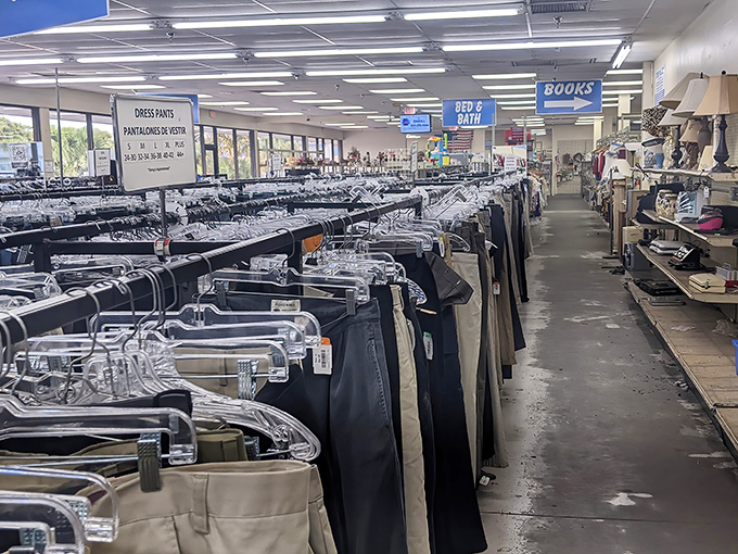 The men's department stretches to the horizon, a sea of slacks and dress pants organized with military precision.