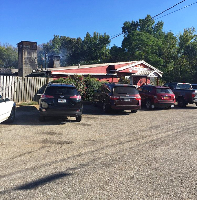The parking lot view: Where smoke signals rise from the pit and cars from across the South gather in barbecue brotherhood.
