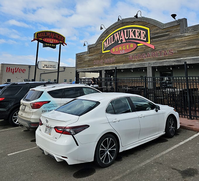 Even the parking lot has a certain allure when you know what awaits inside. Cars gather like pilgrims at a temple of indulgence.