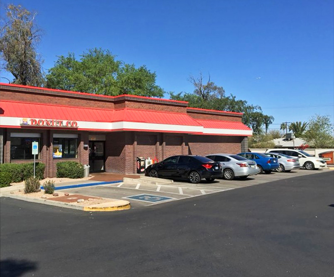 The parking lot view &ndash; where cars gather like pilgrims at a shrine dedicated to the religion of really good breakfast.