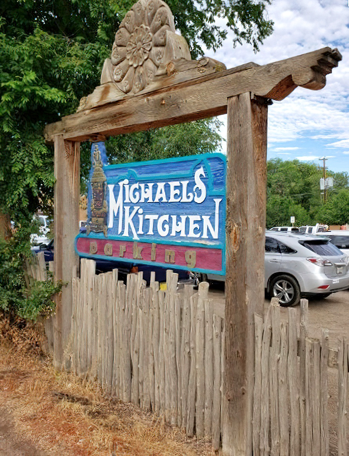 The wooden entrance sign stands as a rustic gateway to flavor town, beckoning hungry travelers with southwestern charm.