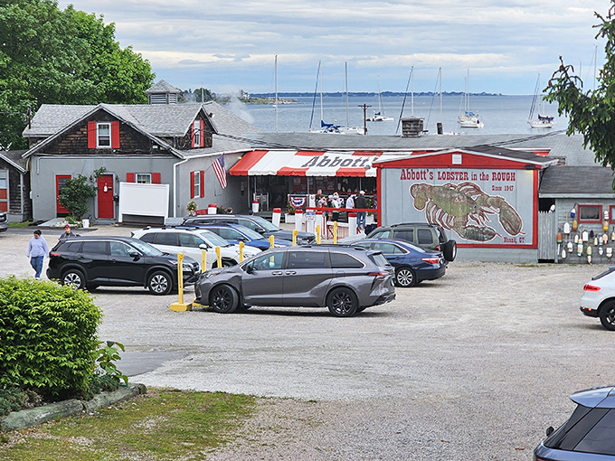 The roadside sign stands like a lighthouse for hungry travelers, guiding them to the promised land of butter-drenched lobster and briny clams.