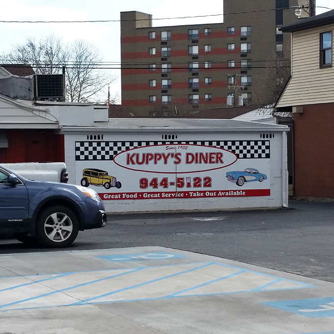 The side view reveals Kuppy's promise of "Great Food &bull; Great Service" and the vintage car illustrations remind us this place has serious history.
