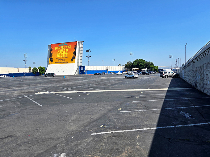 Before the crowds arrive, the asphalt canvas awaits its weekly transformation. By noon, not an empty parking space will remain in sight.