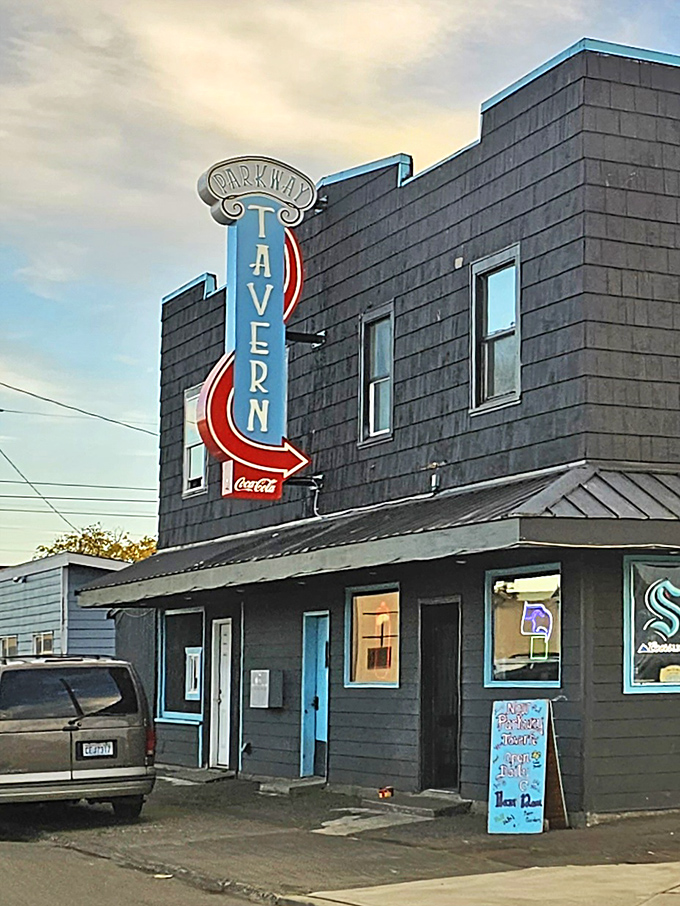 The Parkway Tavern's vintage neon sign beckons with promises of cold drinks and warm conversation.
