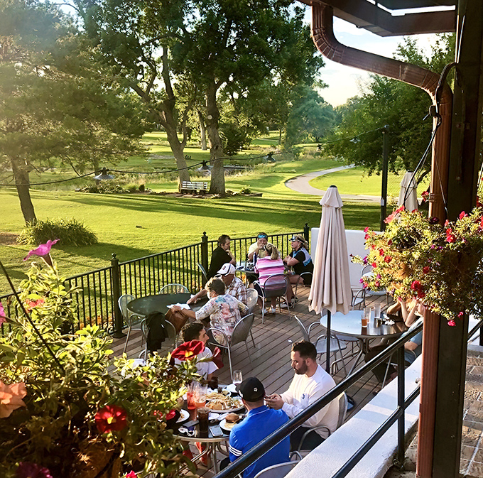 The patio's hanging flower baskets frame a dining experience where nature provides the most appetizing backdrop imaginable.