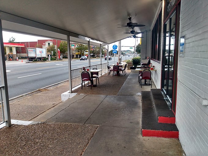 The covered patio offers a front-row seat to Pensacola life passing by, with the added bonus of coffee refills just steps away.
