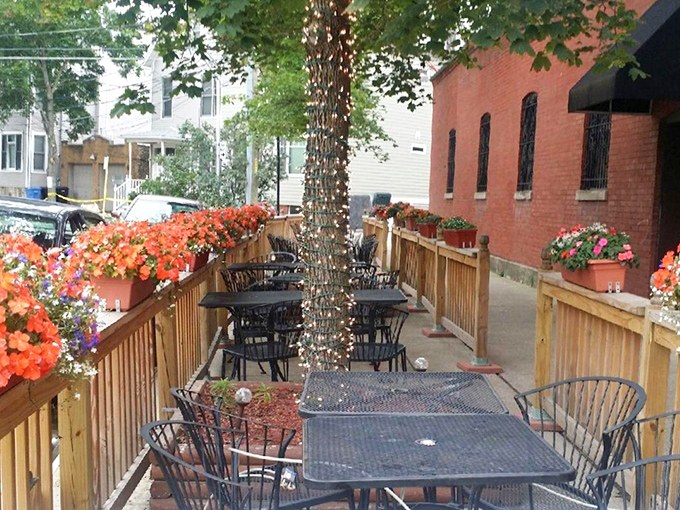 The flower-lined patio creates an unexpected oasis in the city, where summer evenings stretch as long as the conversations over wine and pizza.