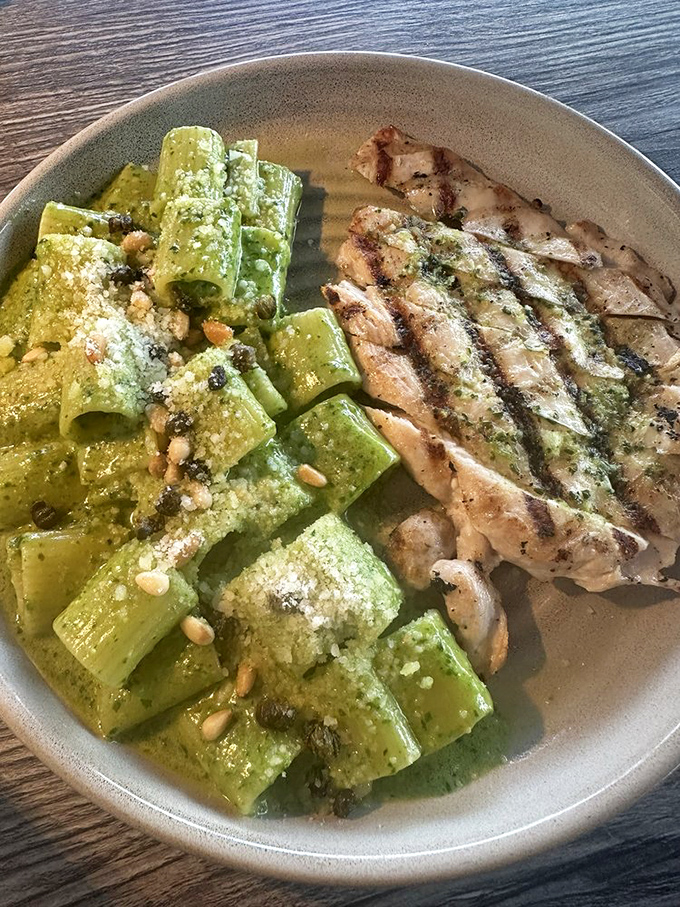 Pesto pasta that makes you twirl your fork with increasing urgency. The grilled chicken alongside provides the perfect protein counterpoint.