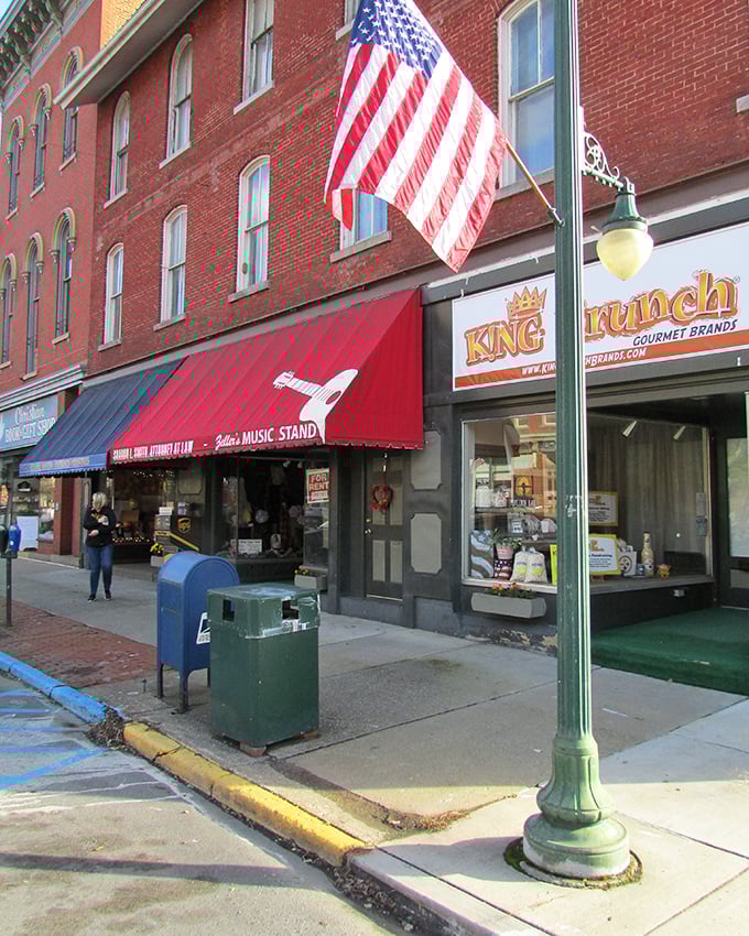Patriotic displays and classic storefronts create a Norman Rockwell scene that feels refreshingly authentic rather than manufactured for tourists.