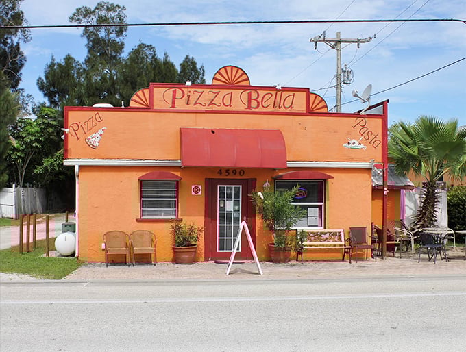 Pizza Bella's tangerine facade promises comfort food with Florida flair. The bench outside says, "Stay awhile," and you absolutely should.
