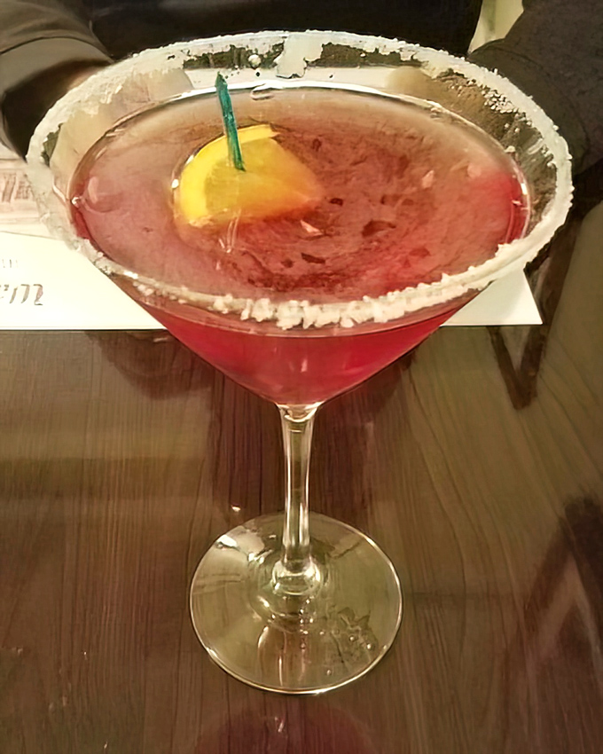 This isn't just a cocktail—it's a ruby-red celebration in a glass, rimmed with promise and garnished with a slice of sunshine.