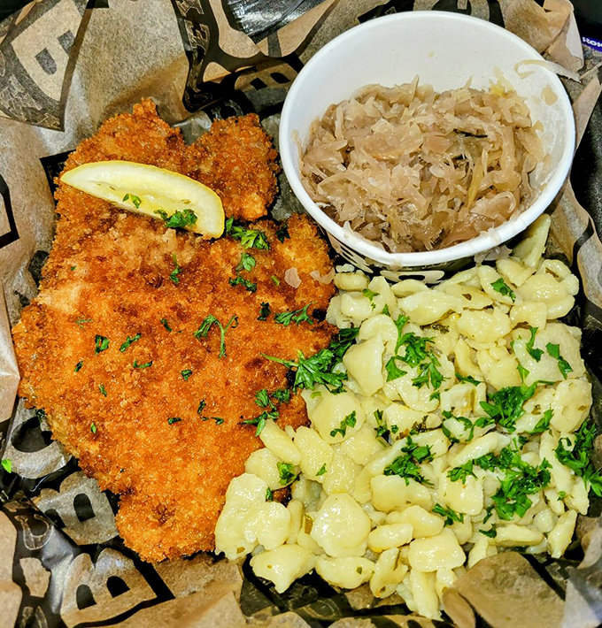 A plate that crosses borders and brings cultures together. The schnitzel and spaetzle are having an international summit with sauerkraut as the mediator.