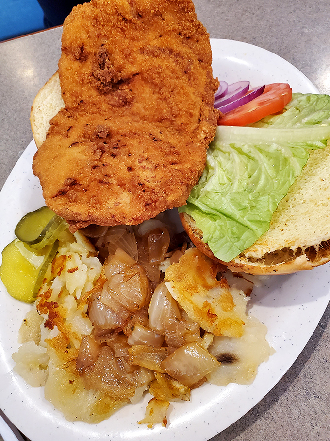 The pork tenderloin sandwich&mdash;an Indiana classic that laughs at the concept of bread-to-meat ratio, hanging gloriously over the edges like a crispy golden halo.