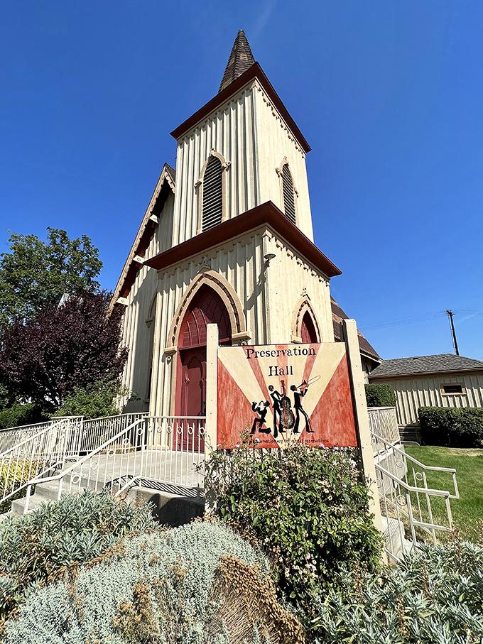 Preservation Hall stands as both architectural gem and cultural center, its white steeple reaching skyward like a defiant finger to time itself.
