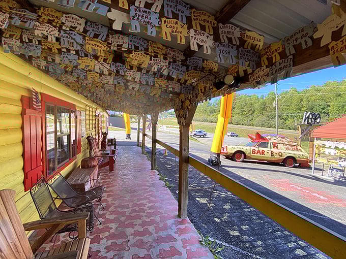 The front porch at Poole's, where wooden pig cutouts hang from the ceiling like a barbecue-themed art installation.