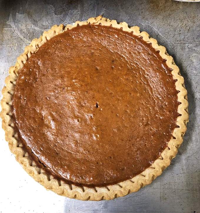 A pumpkin pie that doesn't need a holiday as an excuse to show up. The flaky crust crimped with care holds custard that tastes like autumn memories.
