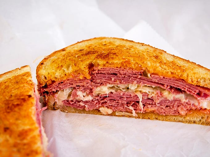 The Reuben reveals its layers like a delicious geological formation &ndash; corned beef, sauerkraut, and Russian dressing between grilled rye.