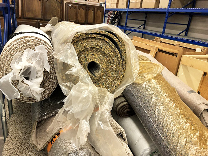 Carpet padding rolls stacked like giant cinnamon buns of home improvement. The unsung heroes of comfortable flooring at prices that won't make you wince.