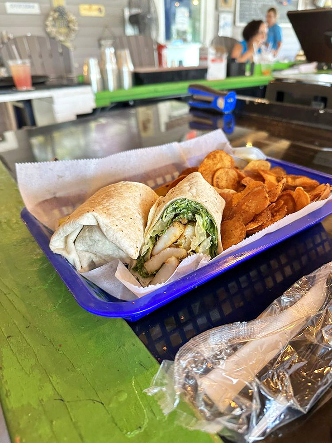 The scallop Caesar wrap paired with kettle chips proves that sometimes the best meals are the ones you can eat without requiring silverware or formality.