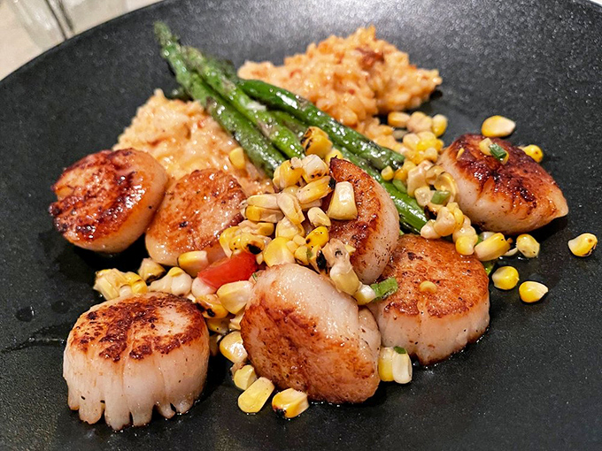 Perfectly seared scallops nestled among sweet corn and asparagus—ocean candy with a summer vegetable party that makes your fork want to dance.