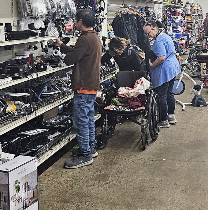 Serious shoppers in their natural habitat, proving that thrifting is both an art form and a competitive sport worthy of Olympic recognition.