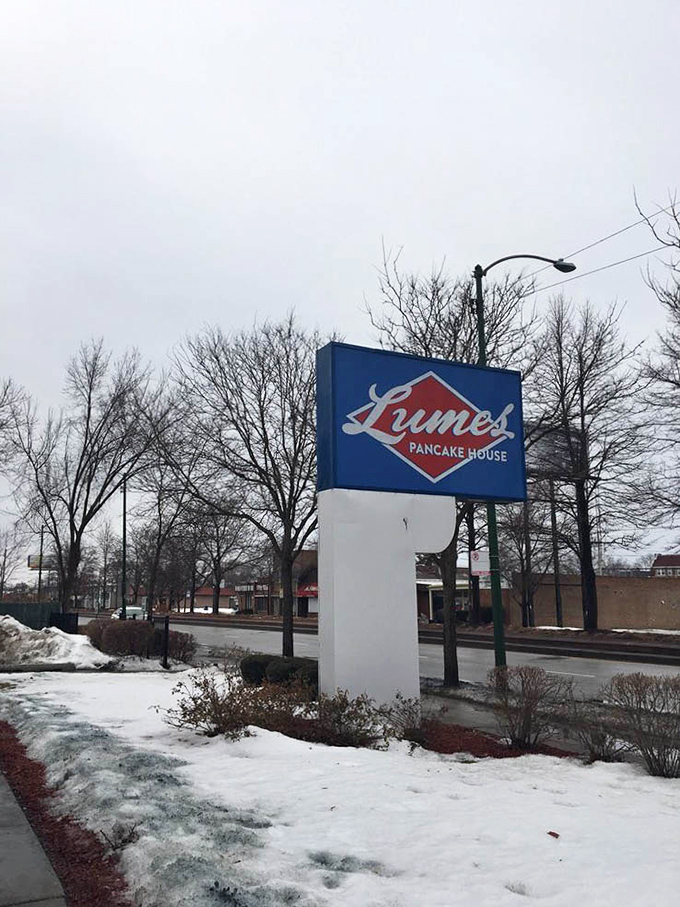 Even in winter's grip, the Lumes sign stands defiant &ndash; a blue and red beacon promising warm pancakes in a cold world.