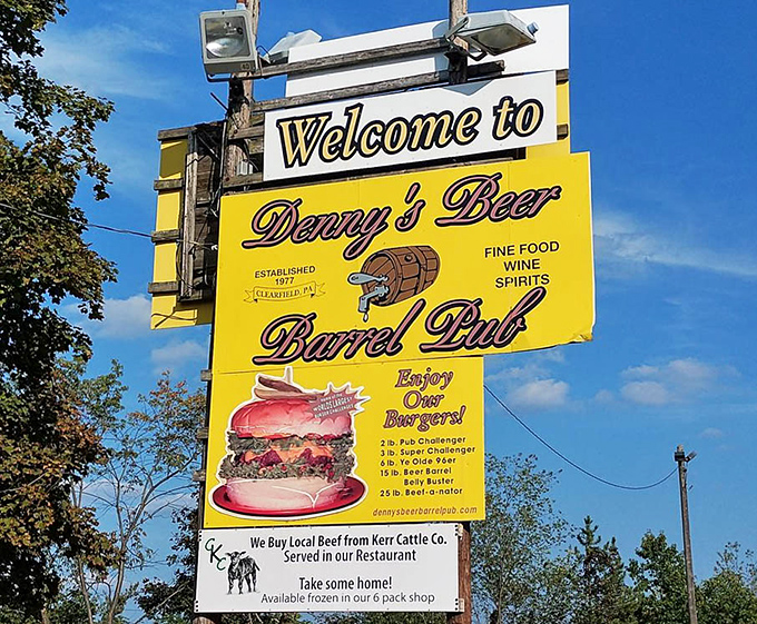 The roadside sign proudly announces burger challenges that range from ambitious to absolutely absurd. Two pounds is just the starting point!