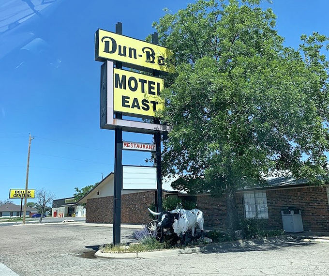 The iconic sign stands as a beacon for hungry travelers, promising honest food without pretense - the longhorn statue nodding in approval.