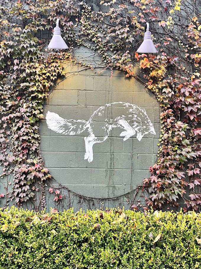 The iconic fox logo, framed by seasonal ivy, tells you you've arrived somewhere special. Nature and design in perfect harmony.