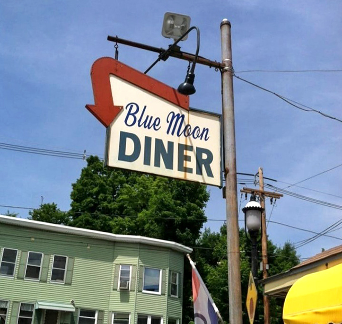 The iconic arrow sign points the way to diner nirvana. Against a blue Massachusetts sky, it's been guiding hungry travelers for generations.