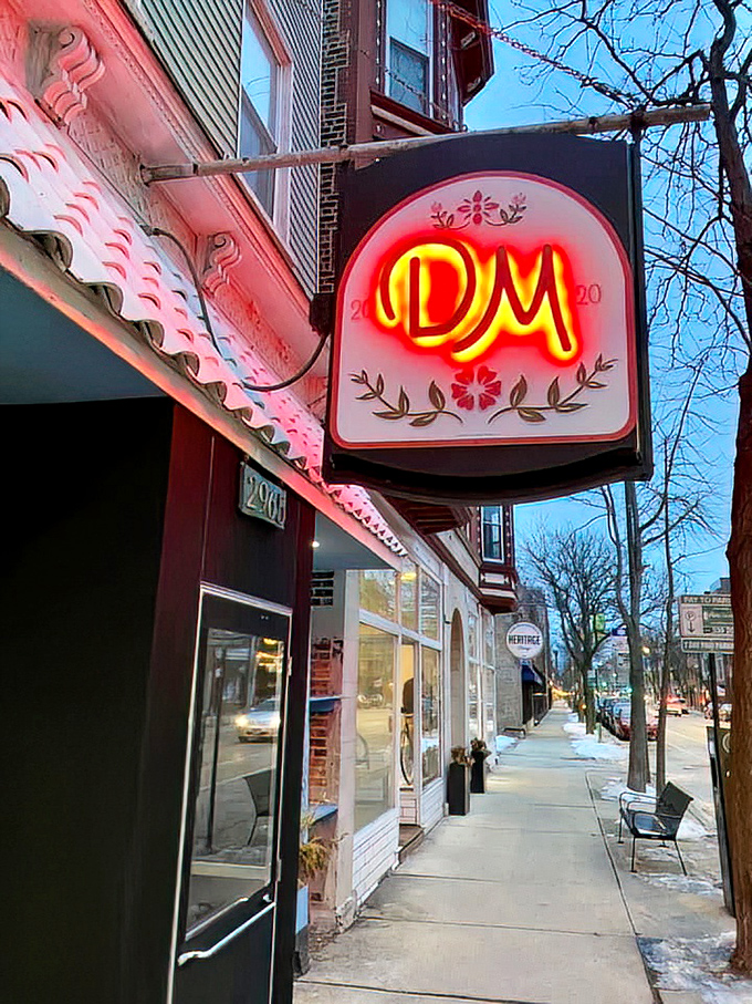 The illuminated signage glowing against the evening sky acts like a beacon drawing hungry souls to this neighborhood treasure worth finding.