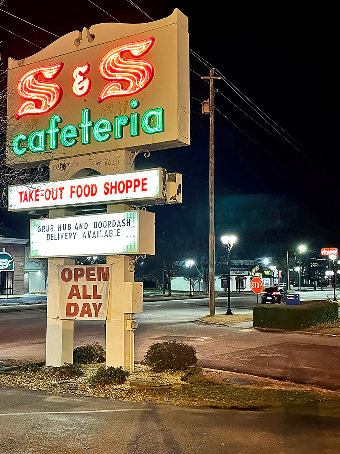 The neon sign glows like a lighthouse in the night, guiding hungry travelers to a port of culinary comfort.