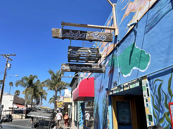 The wooden sign swinging in the ocean breeze promises exactly what's inside: "Good Times & Great Food." Truth in advertising at its finest.