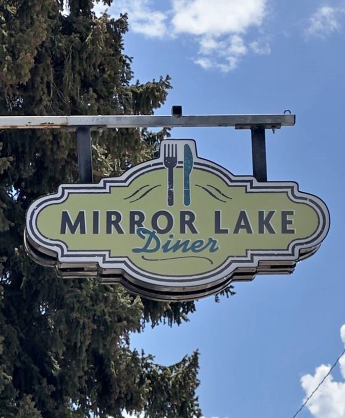 The iconic sign stands as a beacon for hungry travelers, promising good food and mountain hospitality just beyond those pine trees.