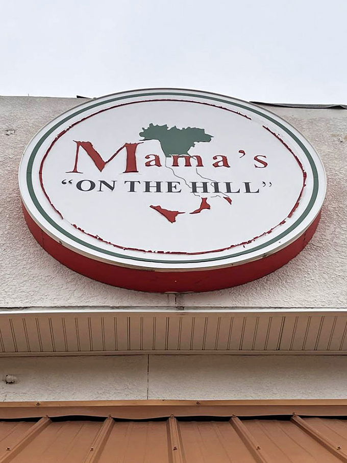 The circular sign featuring Italy's distinctive boot shape reminds you that while you're in Missouri, your taste buds are taking a Mediterranean vacation.