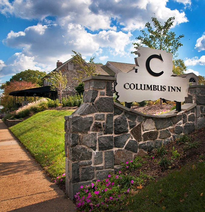 The Columbus Inn sign stands as a stone sentinel, welcoming hungry travelers to this culinary landmark since 1798.