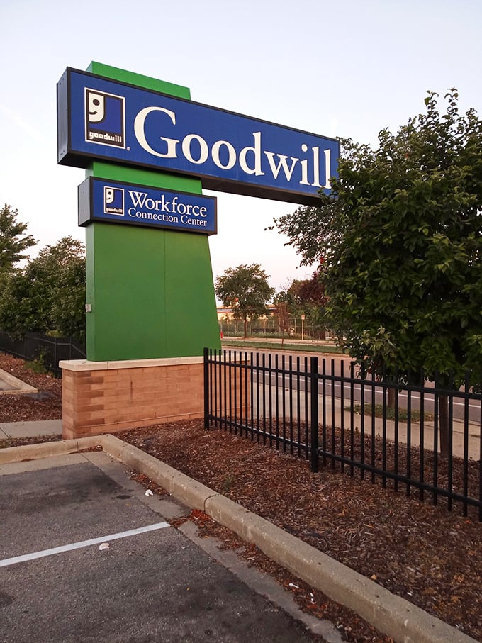 The iconic blue and green sign stands tall, a beacon for bargain hunters and treasure seekers alike. Goodwill: where shopping meets mission.