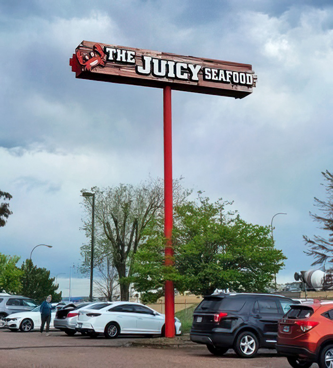 The illuminated sign stands like a lighthouse, guiding hungry travelers to a safe harbor of buttery, garlicky goodness.