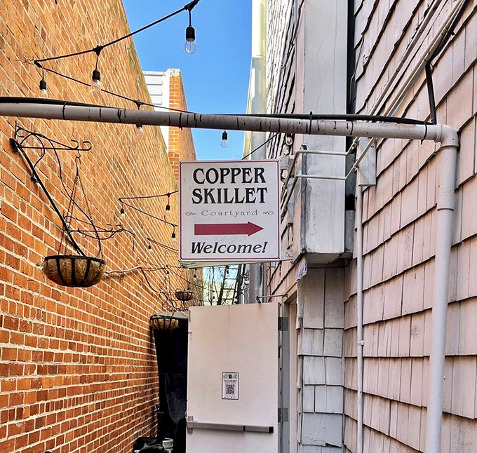 That courtyard sign points the way to breakfast bliss, tucked between buildings like a delicious secret.