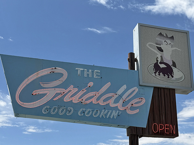The iconic sign stands tall against Nevada's blue sky, the cartoon cat announcing "Good Cookin'" like a promise that's never broken.