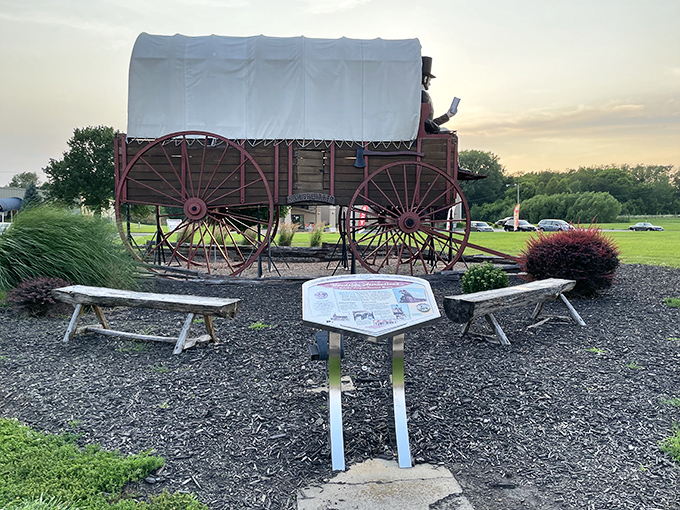 Simple benches invite visitors to contemplate the wagon's magnificence. "Please don't climb" signs suggest not everyone appreciates art from a distance.