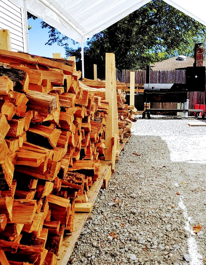 Firewood stacked like money in a vault, except this currency buys you flavor instead of groceries.